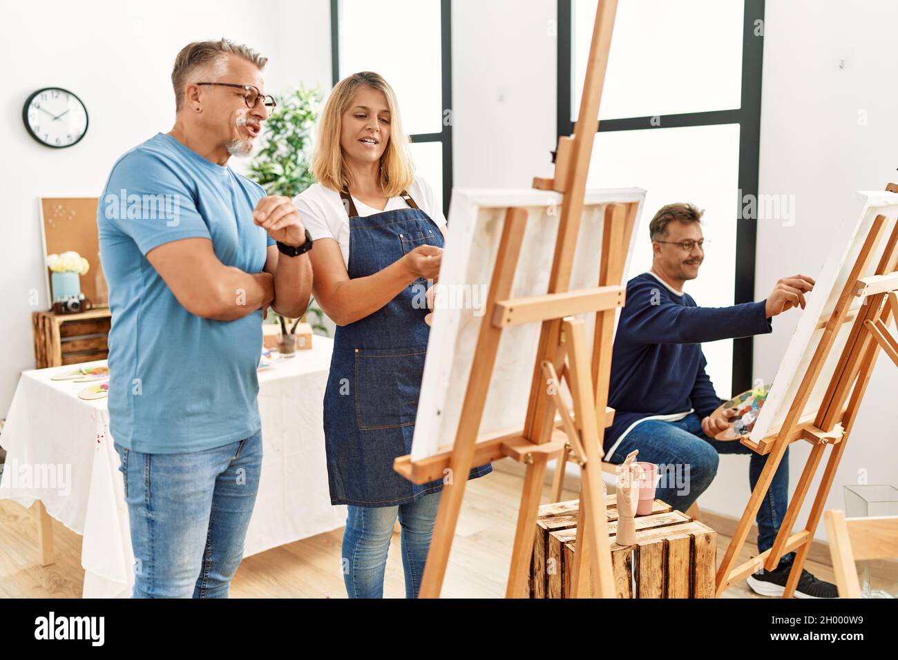 Group of middle age paint students drawing at art studio. Teacher ...