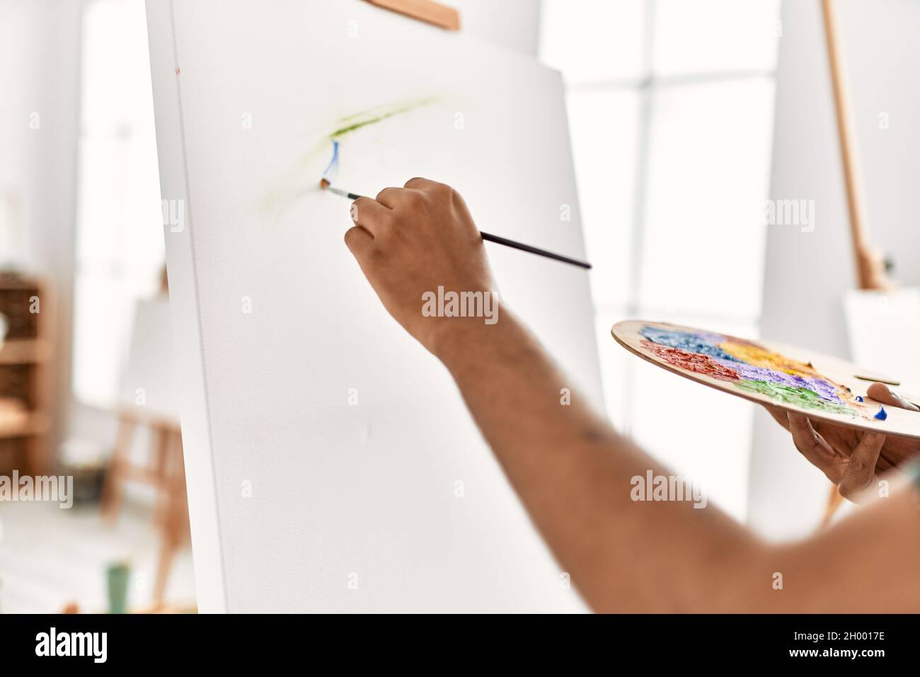 Hand of african american artist man painting at art studio Stock Photo ...