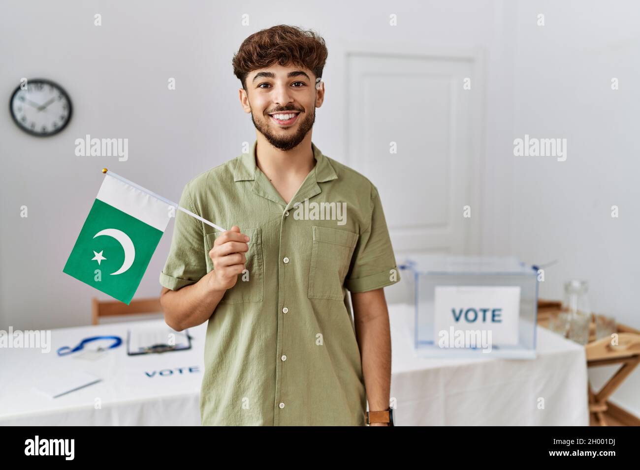 Young arab man at political campaign election holding pakistan flag ...
