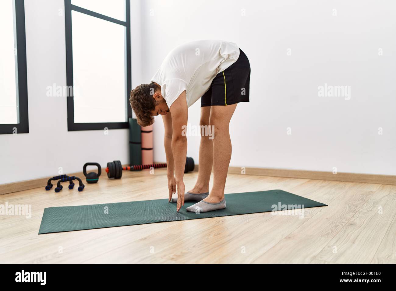 Young arab man stretching at sport center Stock Photo - Alamy