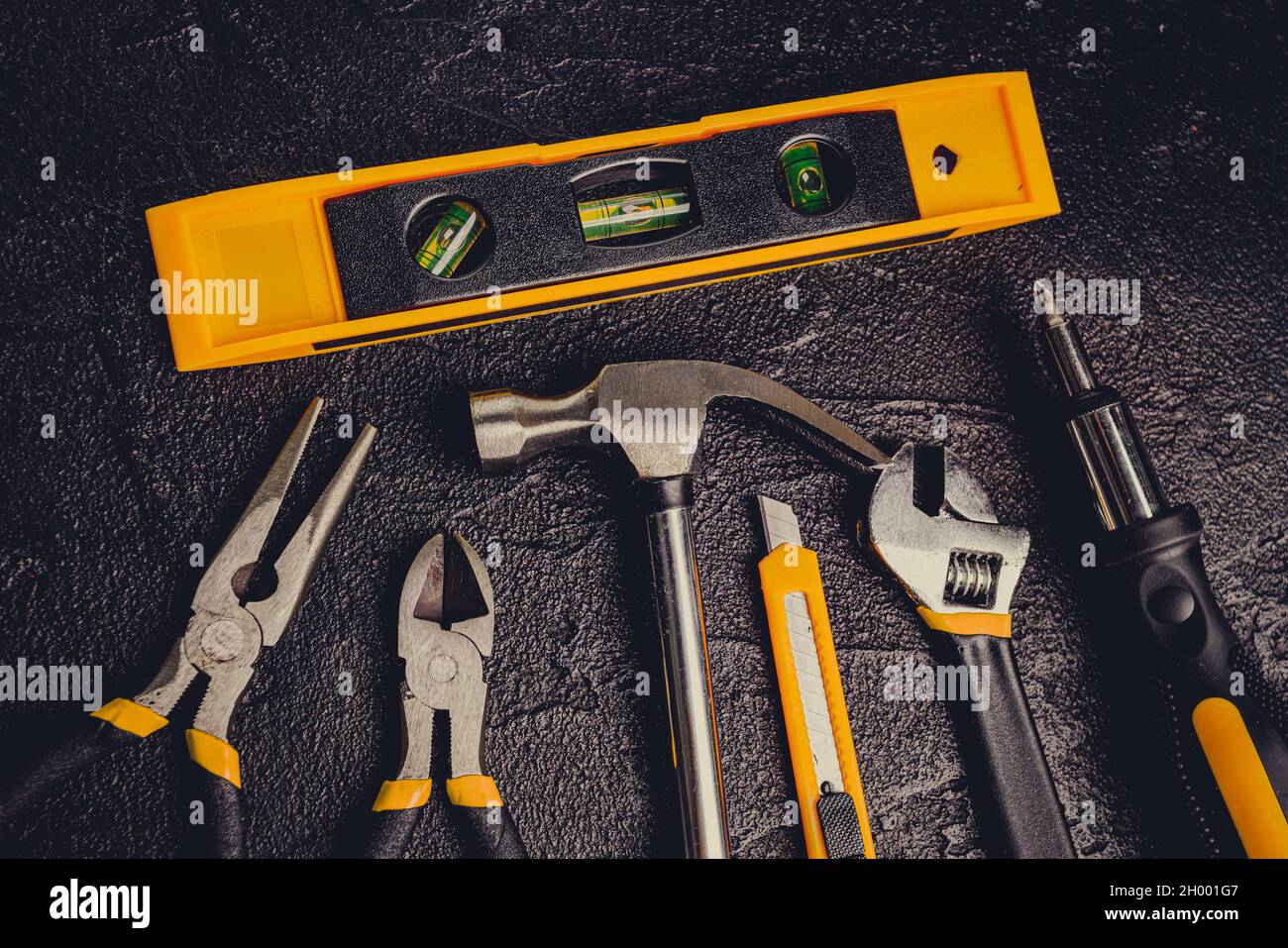 Tools for master builder on a black background Stock Photo - Alamy