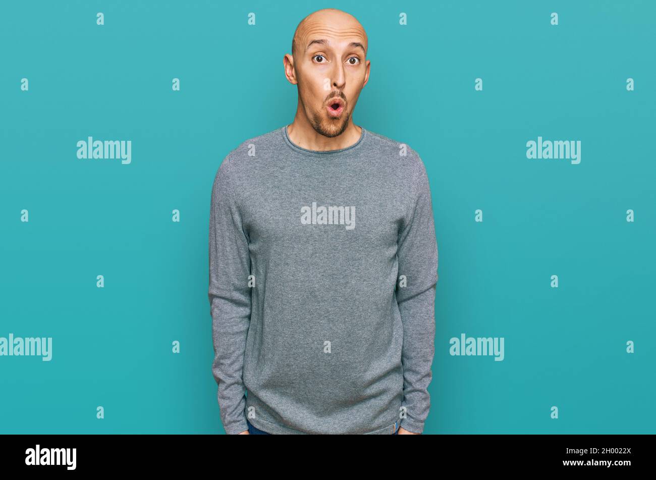 Bald man with beard wearing casual clothes afraid and shocked with ...
