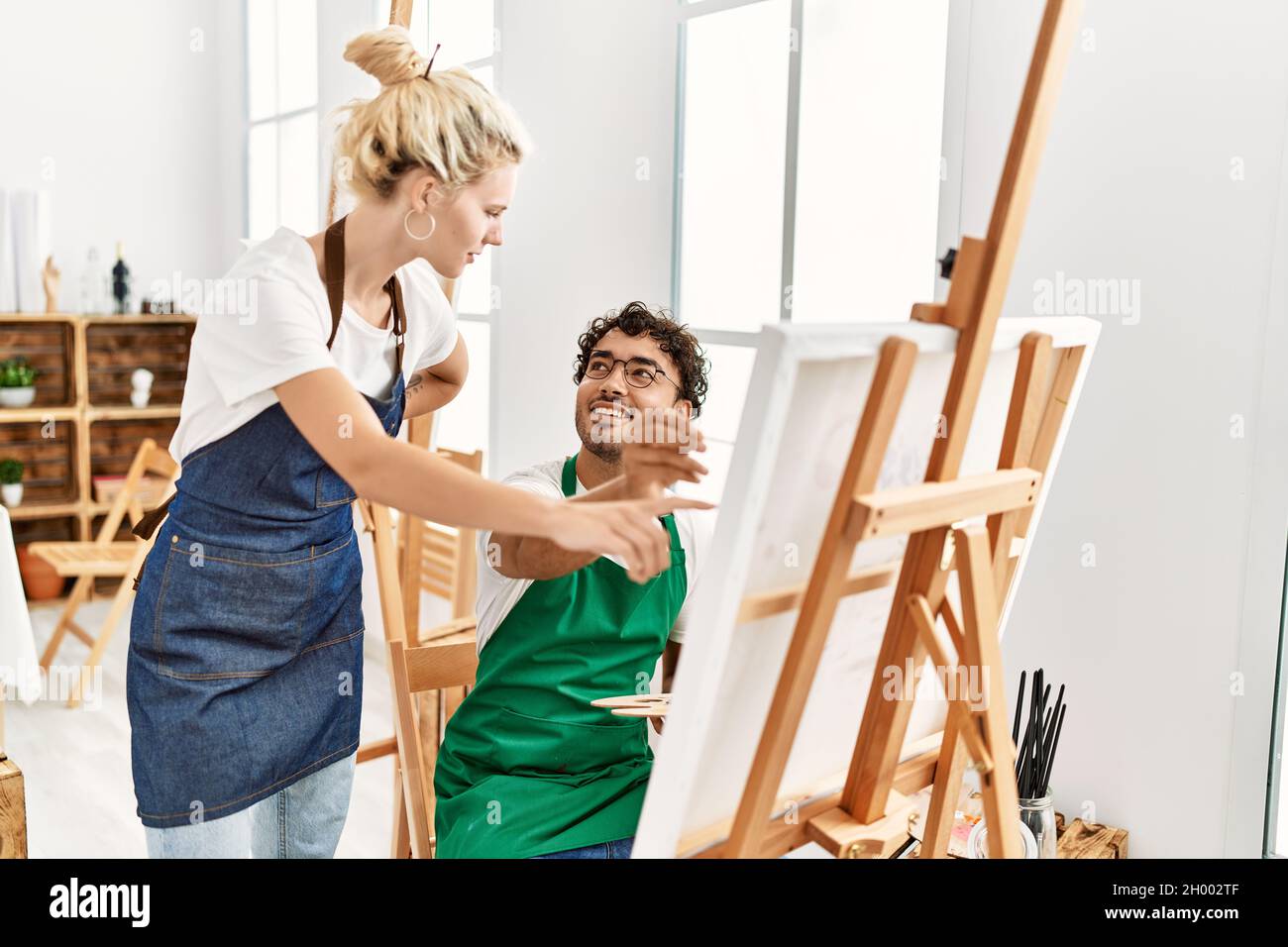 Paint teacher woman teaching to student man at art studio Stock Photo ...