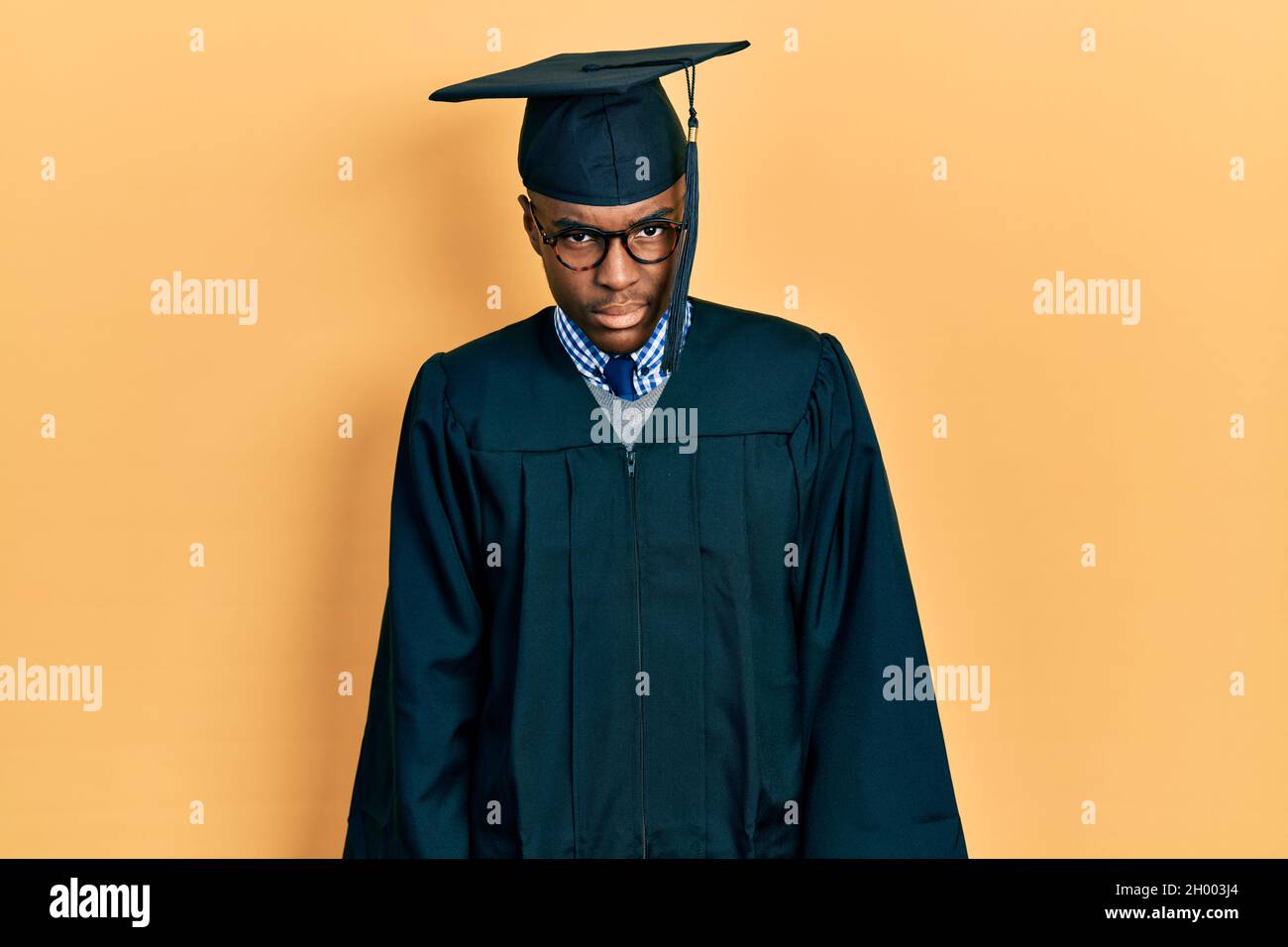 Young african american man wearing graduation cap and ceremony robe ...