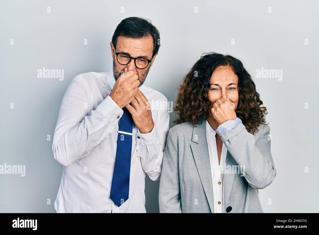 Middle age couple of hispanic woman and man wearing business office ...