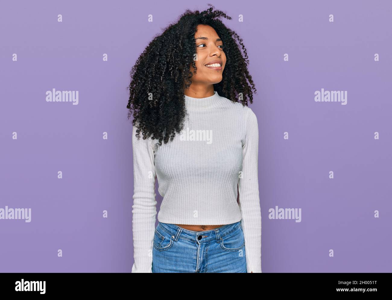 Young african american girl wearing casual clothes looking away to side ...