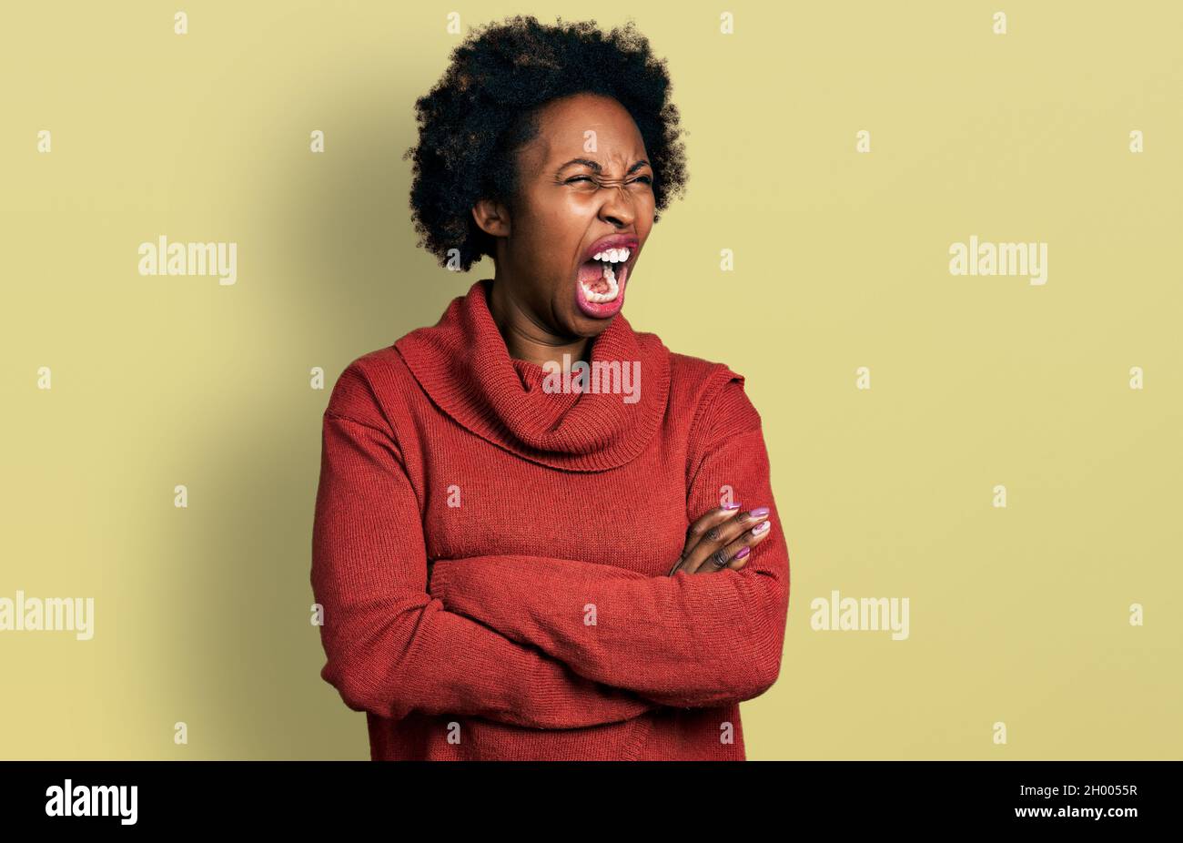 African american woman with afro hair with arms crossed gesture angry ...
