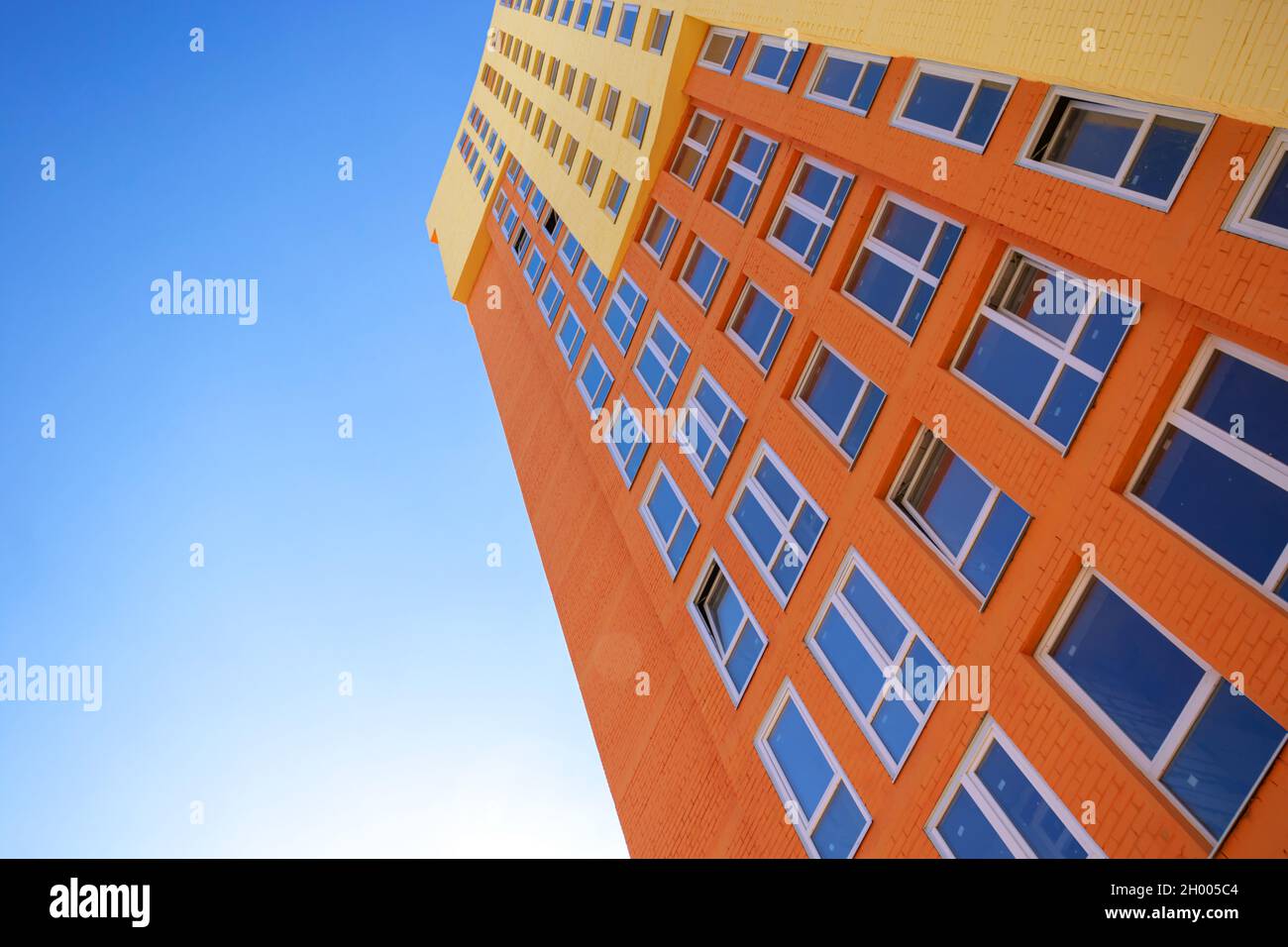 Multi-colored modern residential high-rise building with many glass ...