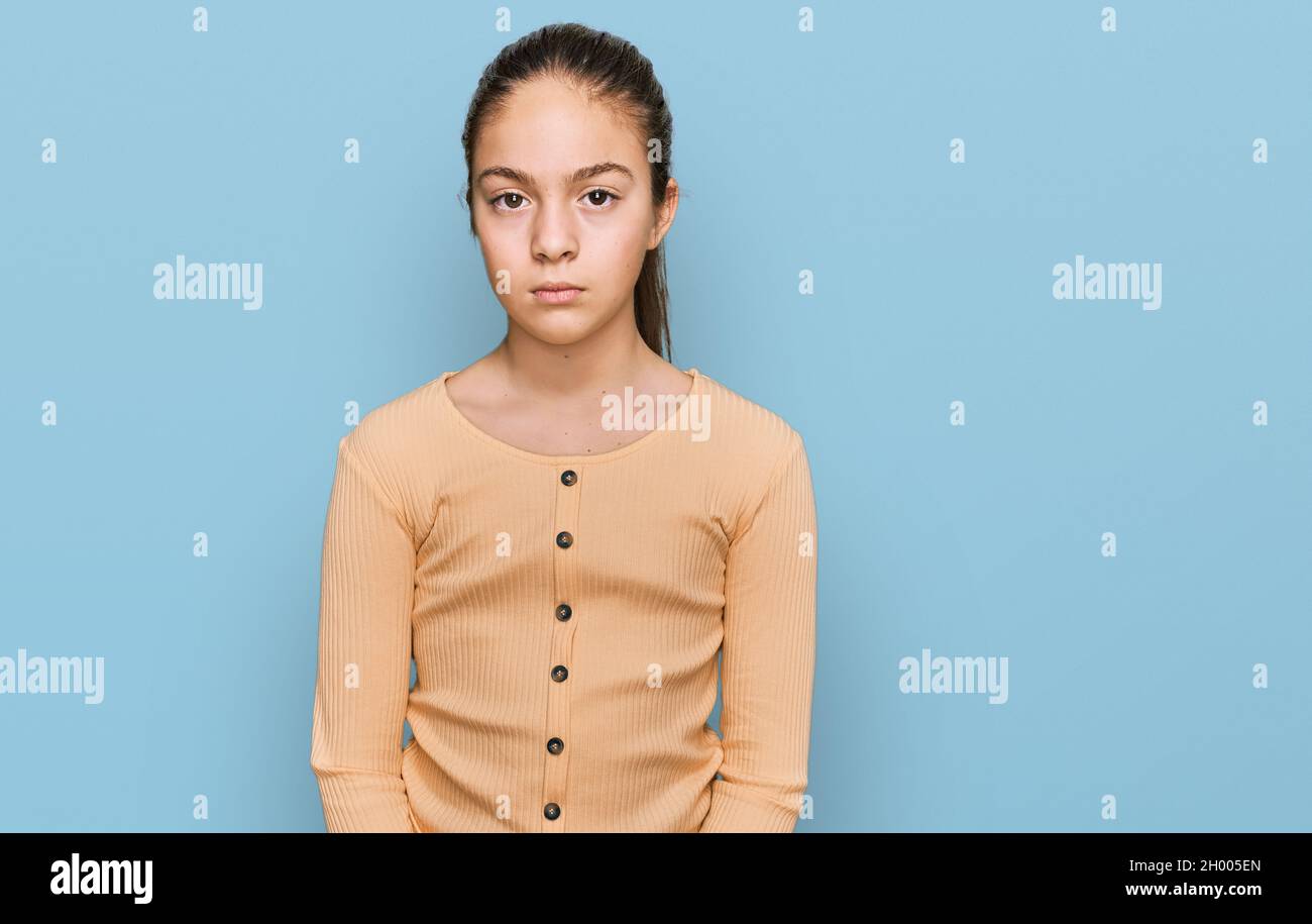 Beautiful brunette little girl wearing casual sweater skeptic and ...