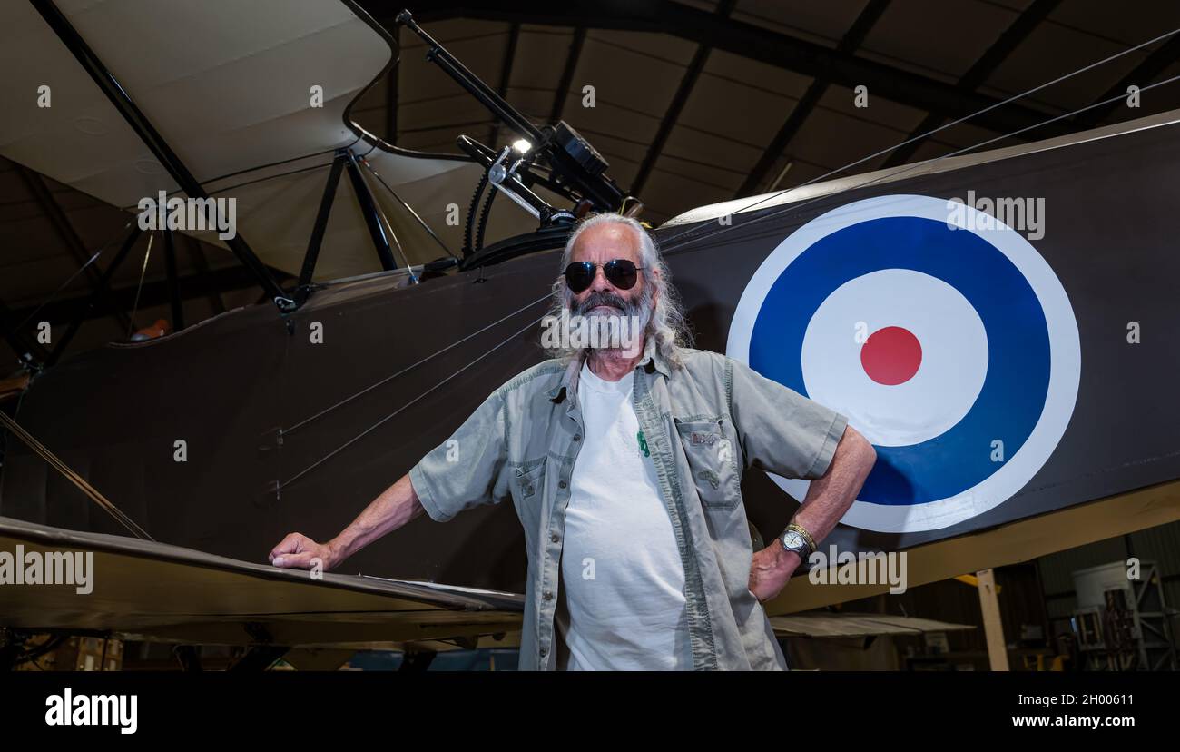 Senior man at replica WWI Sopwith 1 1/2 Strutter aeroplane biplane ...