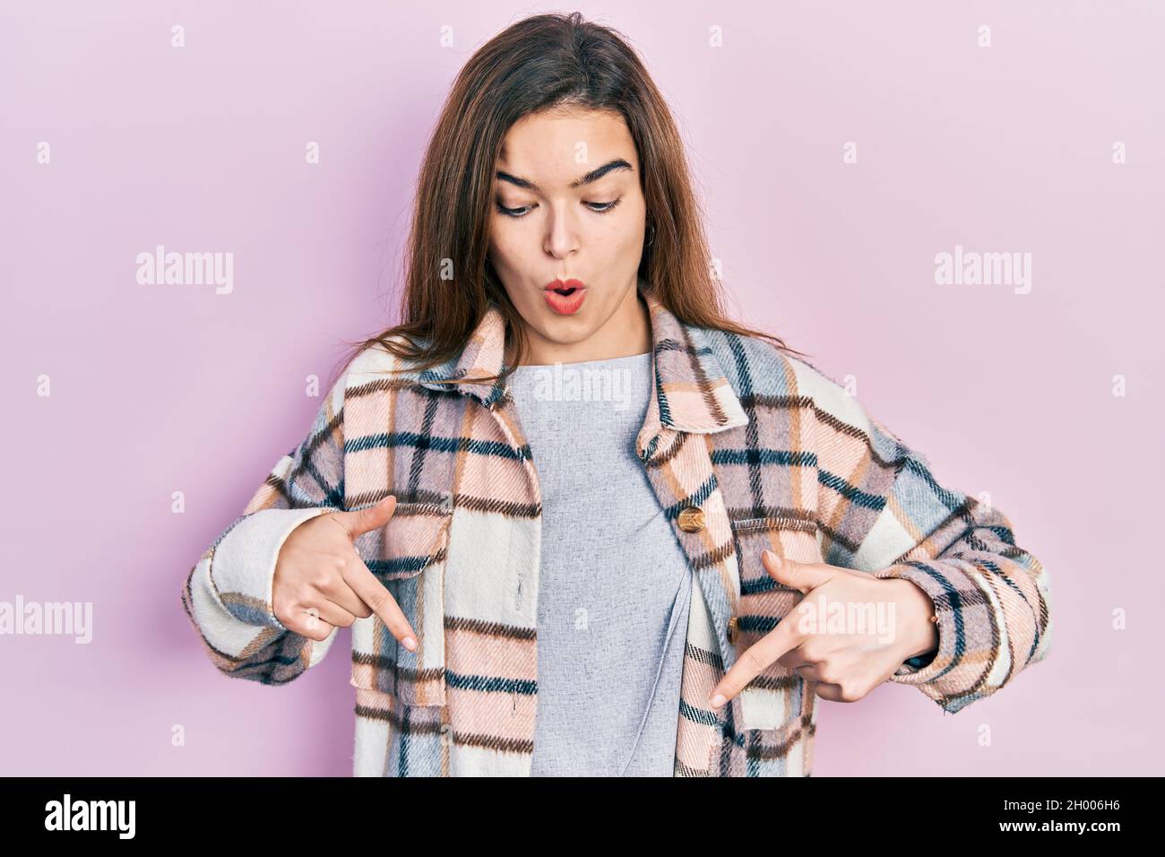 Young caucasian girl wearing casual clothes pointing down with fingers ...