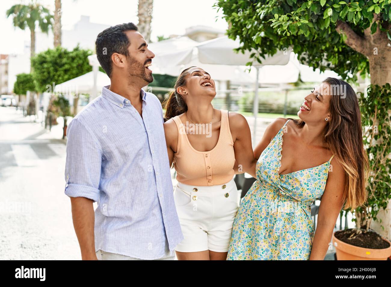 Three hispanic friends smiling happy and hugging at the city Stock ...