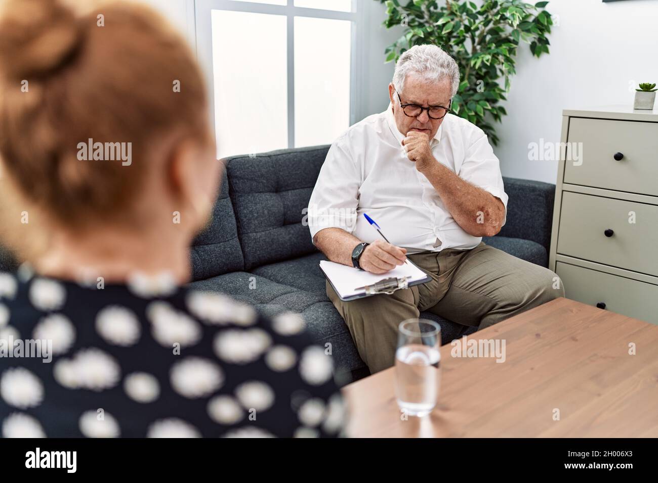 Senior psychologist man at consultation office feeling unwell and ...