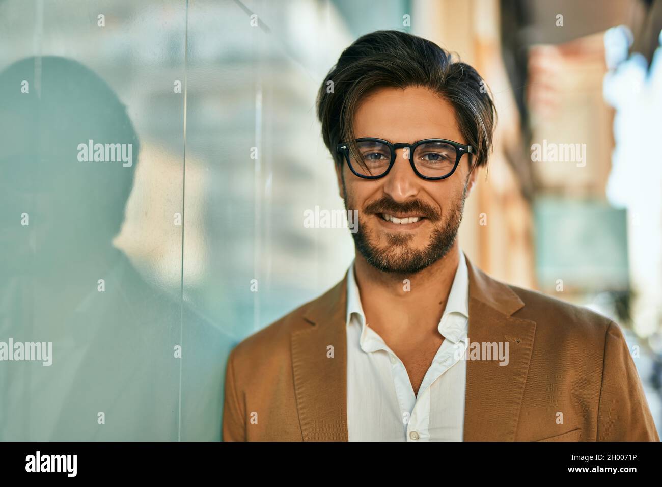 Young hispanic businessman smiling happy standing at the city Stock ...
