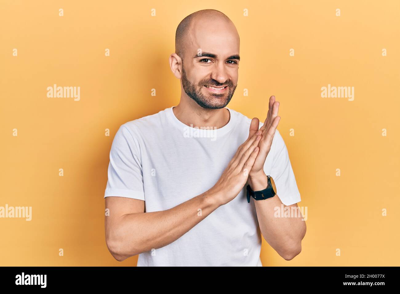 Young bald man wearing casual white t shirt clapping and applauding ...