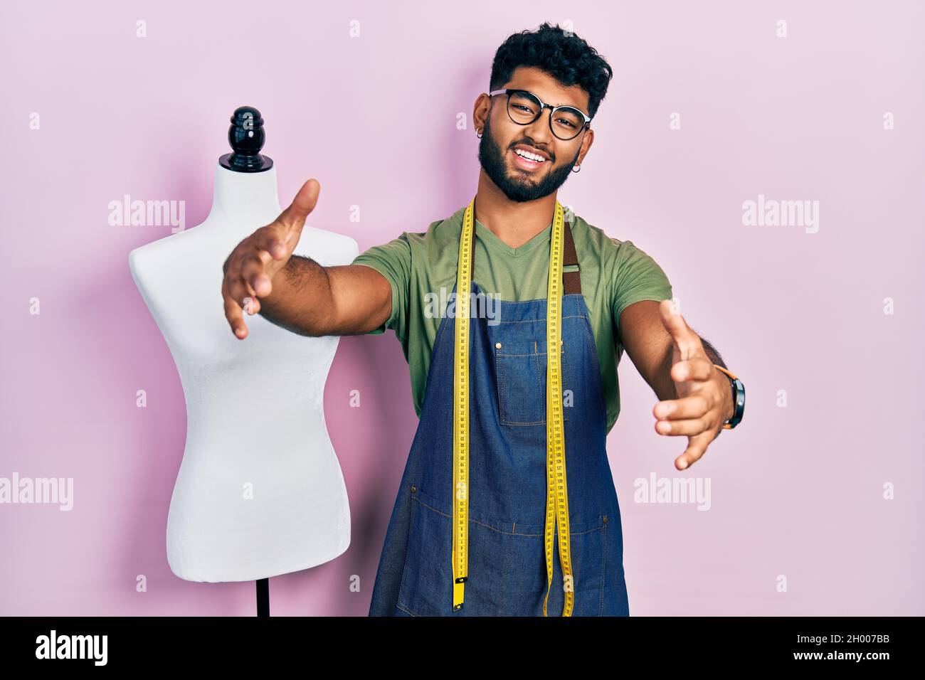 Arab man with beard dressmaker designer wearing atelier apron looking ...