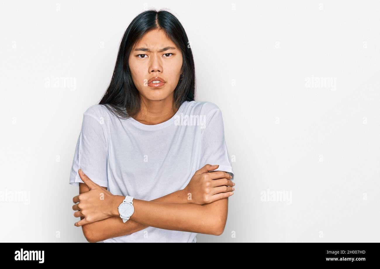 Beautiful young asian woman wearing casual white t shirt shaking and ...