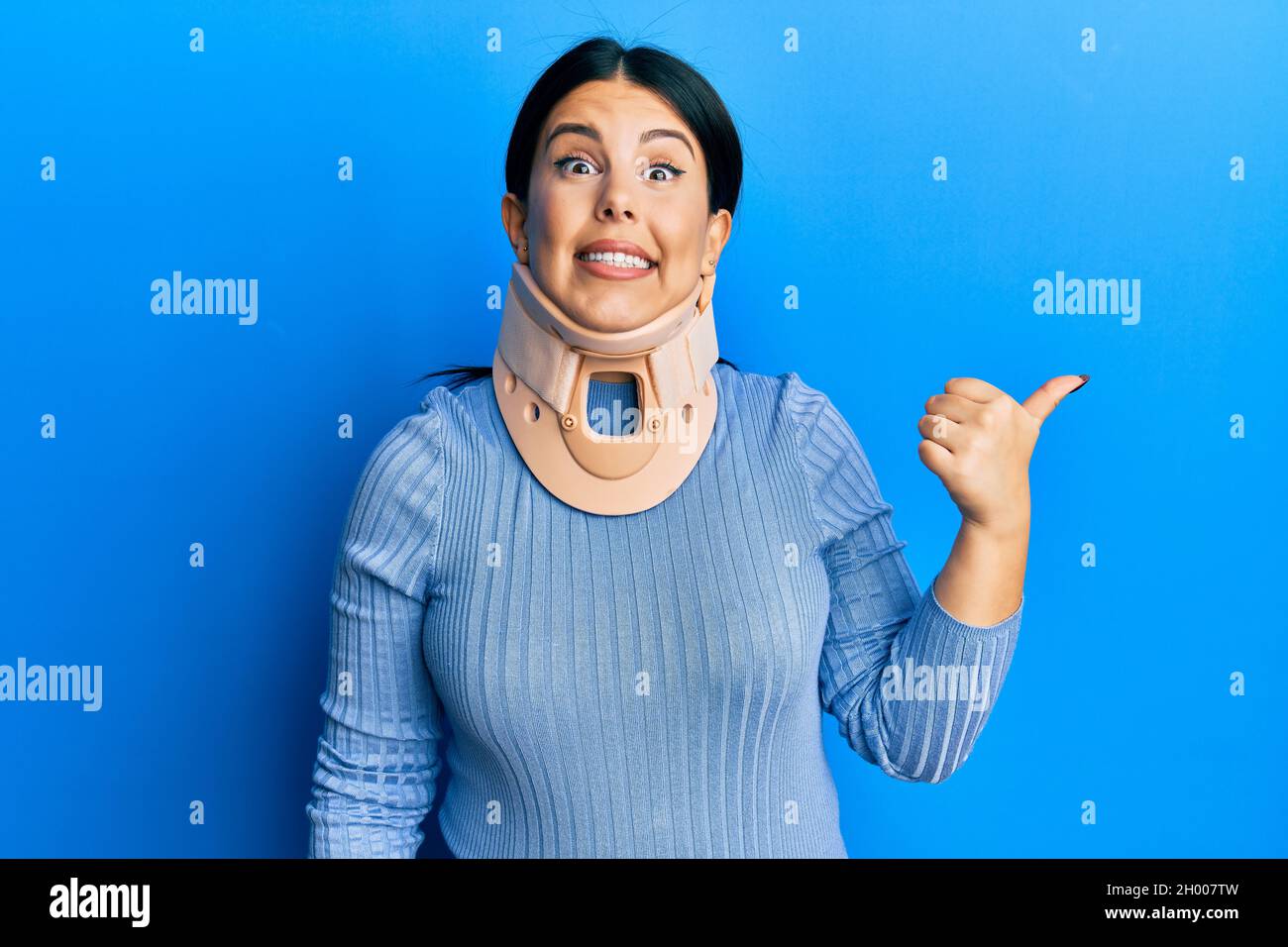 Beautiful brunette woman wearing cervical collar smiling with happy ...