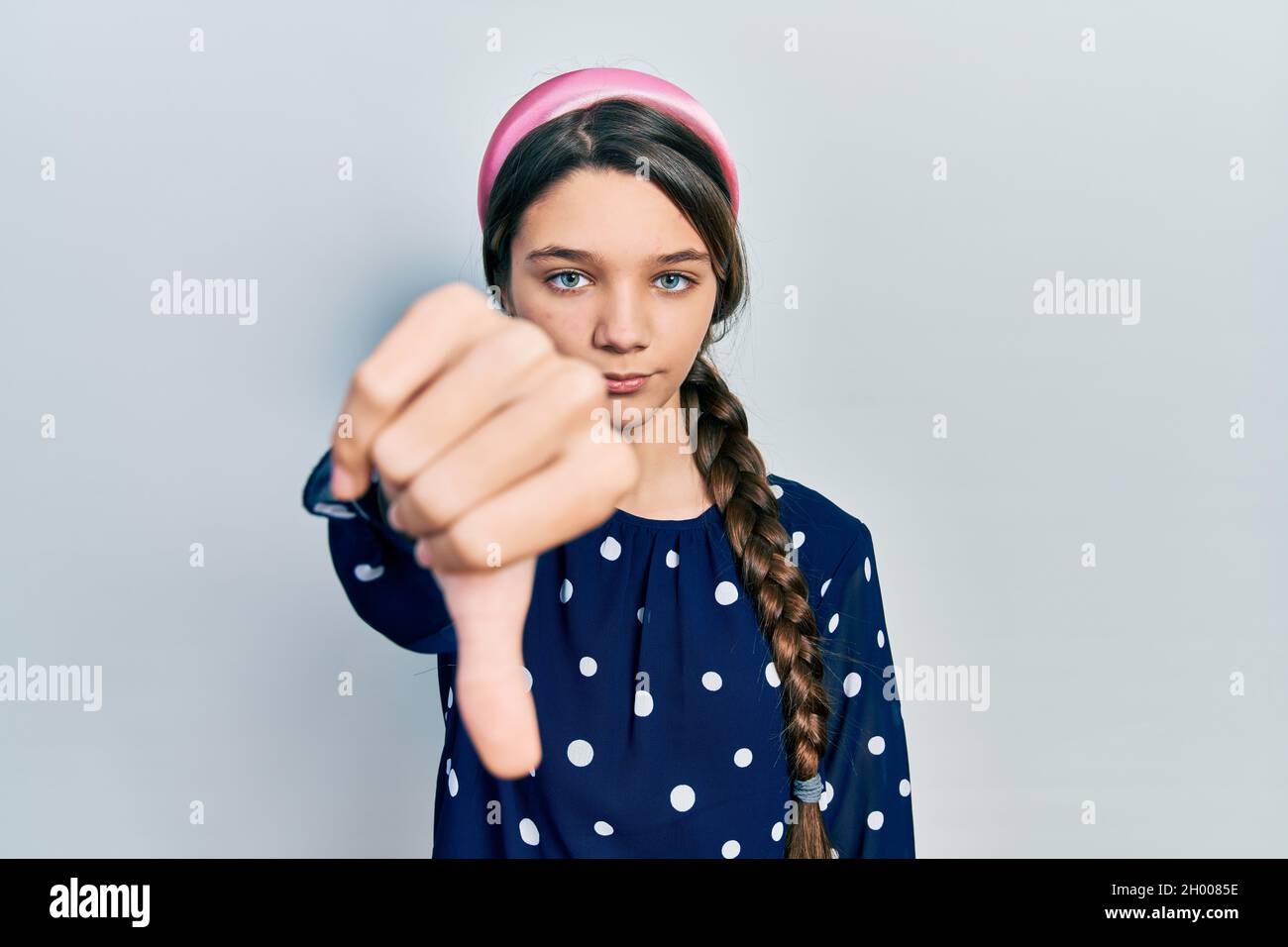 Young brunette girl wearing elegant look looking unhappy and angry ...