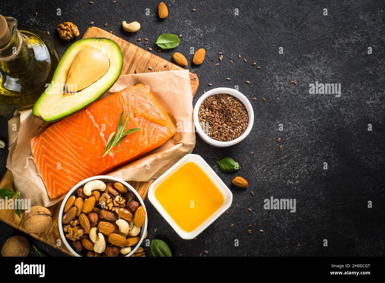 Healthy fats products at black background Stock Photo - Alamy
