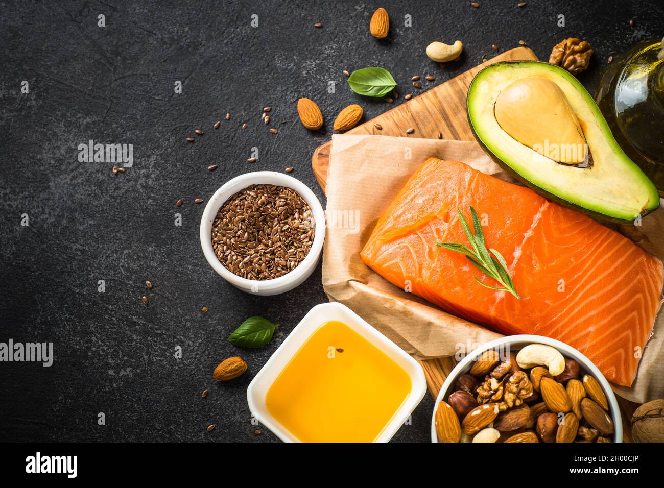 Healthy fats products at black background Stock Photo - Alamy
