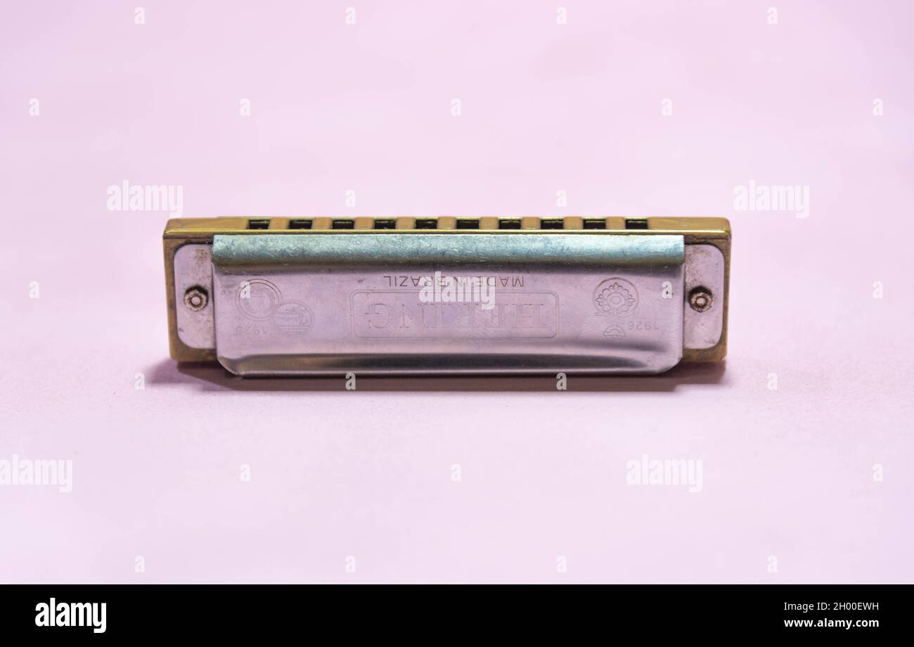 Harmonica. Musical instrument. Pink background. Wind instrument. Jazz ...