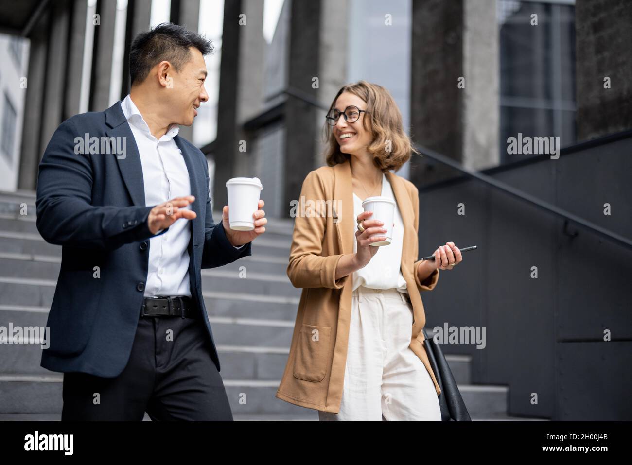Business people walking and talking in city Stock Photo - Alamy