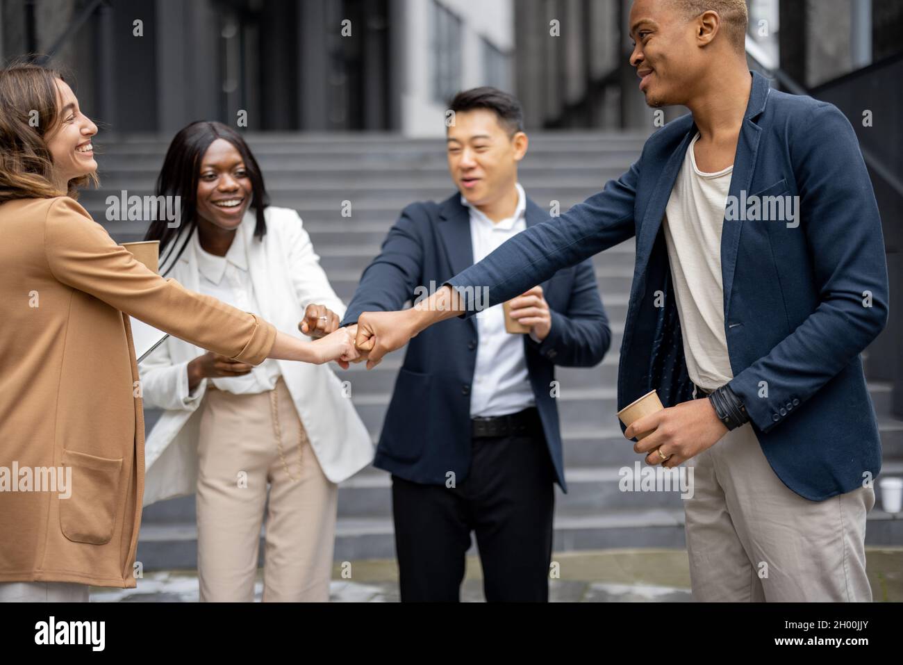 Multiracial business team bumping fists each other Stock Photo - Alamy Multiracial business team bumping fists each other Stock Photo - Alamy