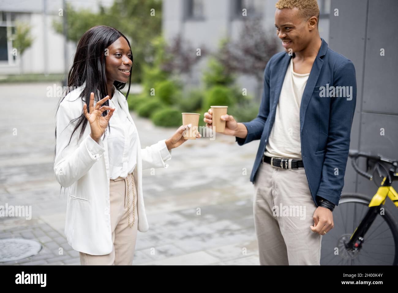 Business people talk and drink coffee outdoors Stock Photo - Alamy