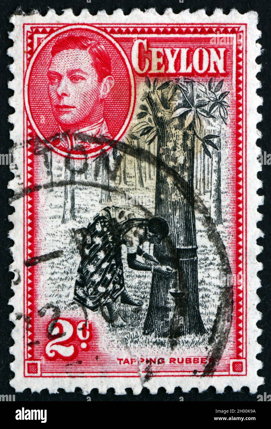 SRI LANKA - CIRCA 1938: a stamp printed in Sri Lanka shows Tapping ...