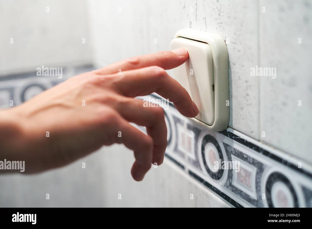 A person's hand touching the light switch Stock Photo - Alamy