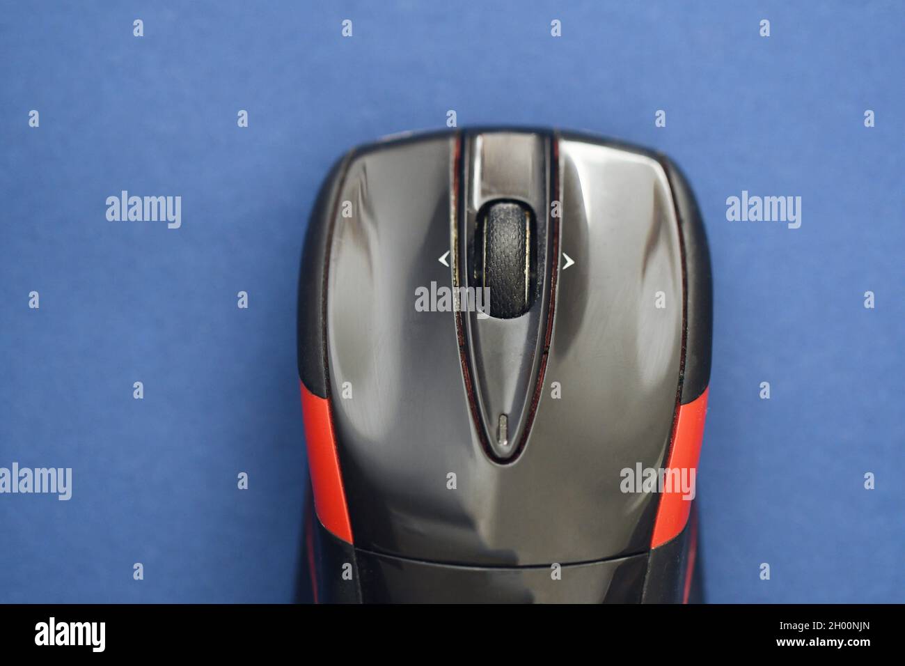 Overhead of a black and red computer mouse on a blue background Stock ...