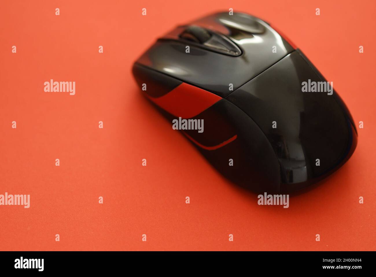Photo of a black and red computer mouse on a red background Stock Photo ...