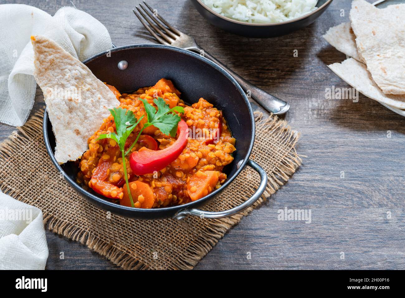 Indian vegetarian red lentil dhal curry with roti and rice Stock Photo ...