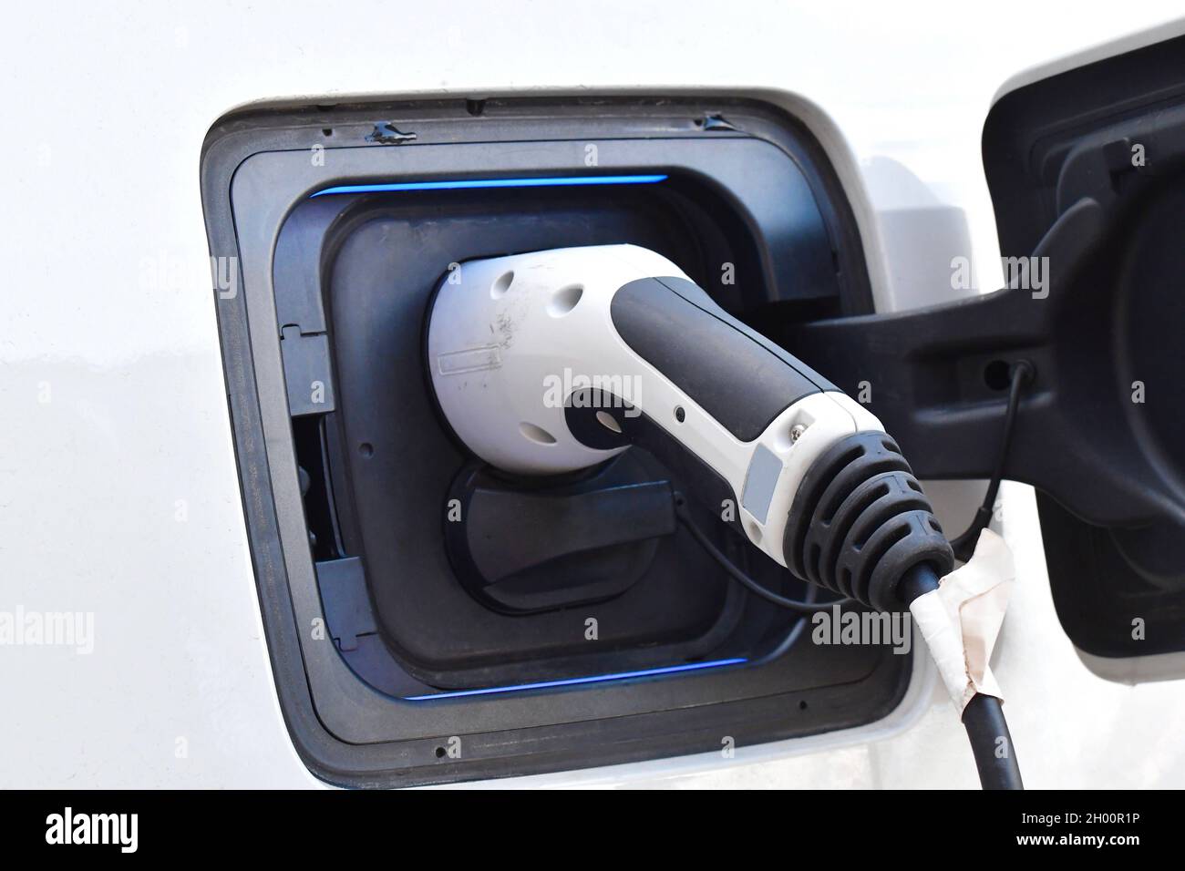 Closeup of a white electric car being charged with electricity Stock ...