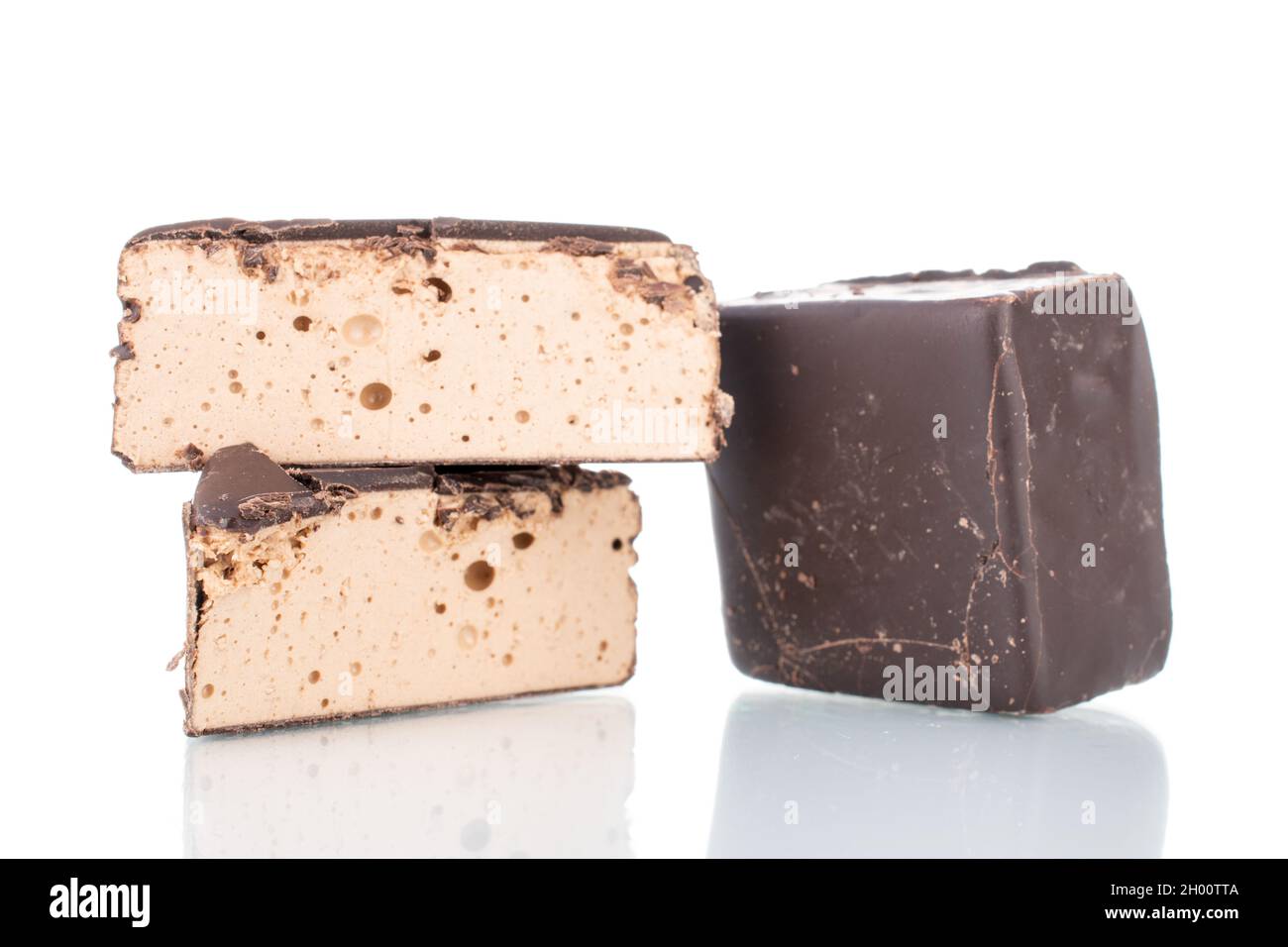 Two halves and one whole sweet chocolate candies, close-up, isolated on ...