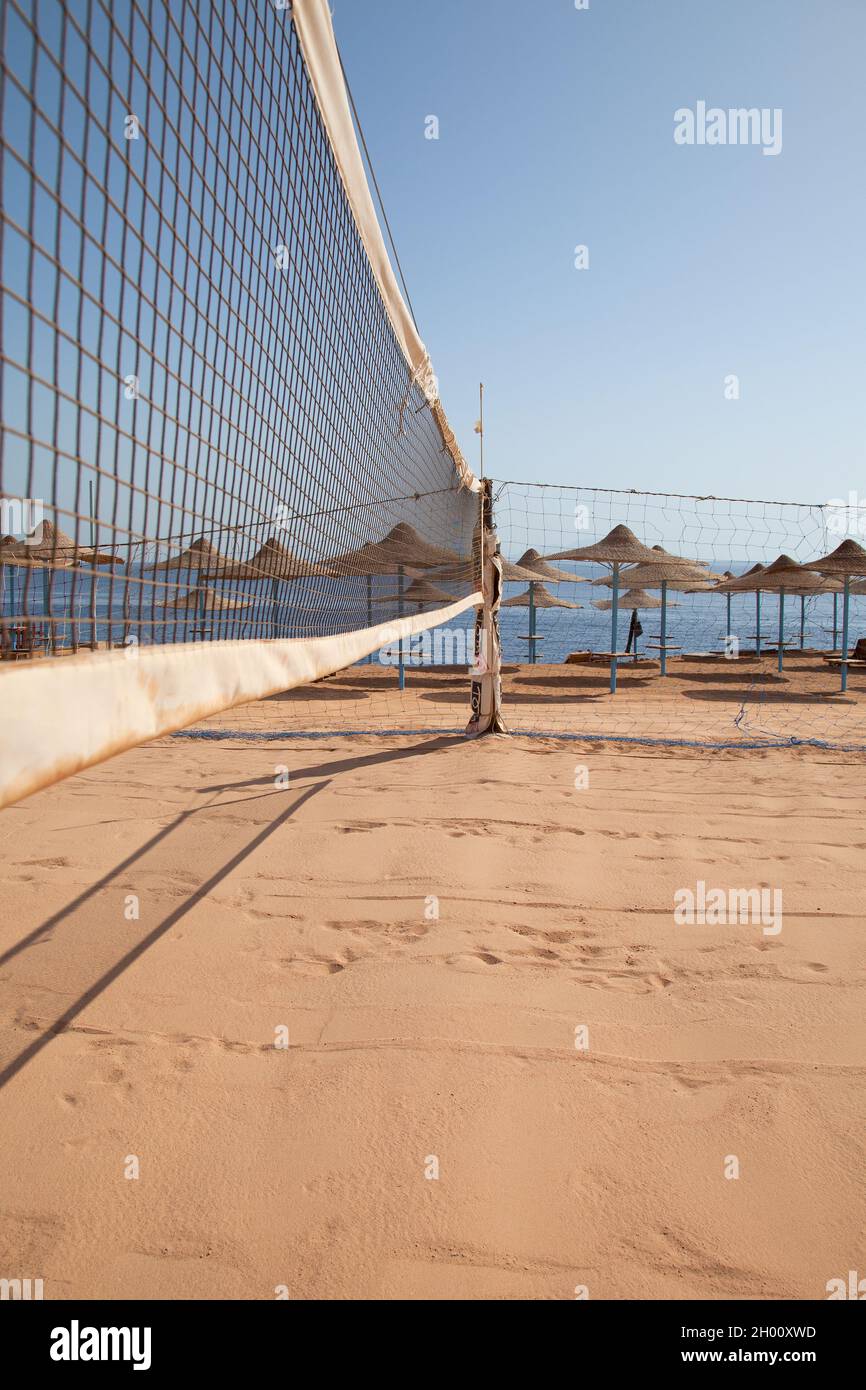 Volleyball net on tropical beach with blue sky. Closeup of net netting ...