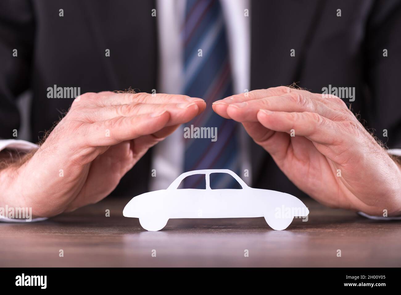 Concept of car insurance with hands over a car Stock Photo - Alamy