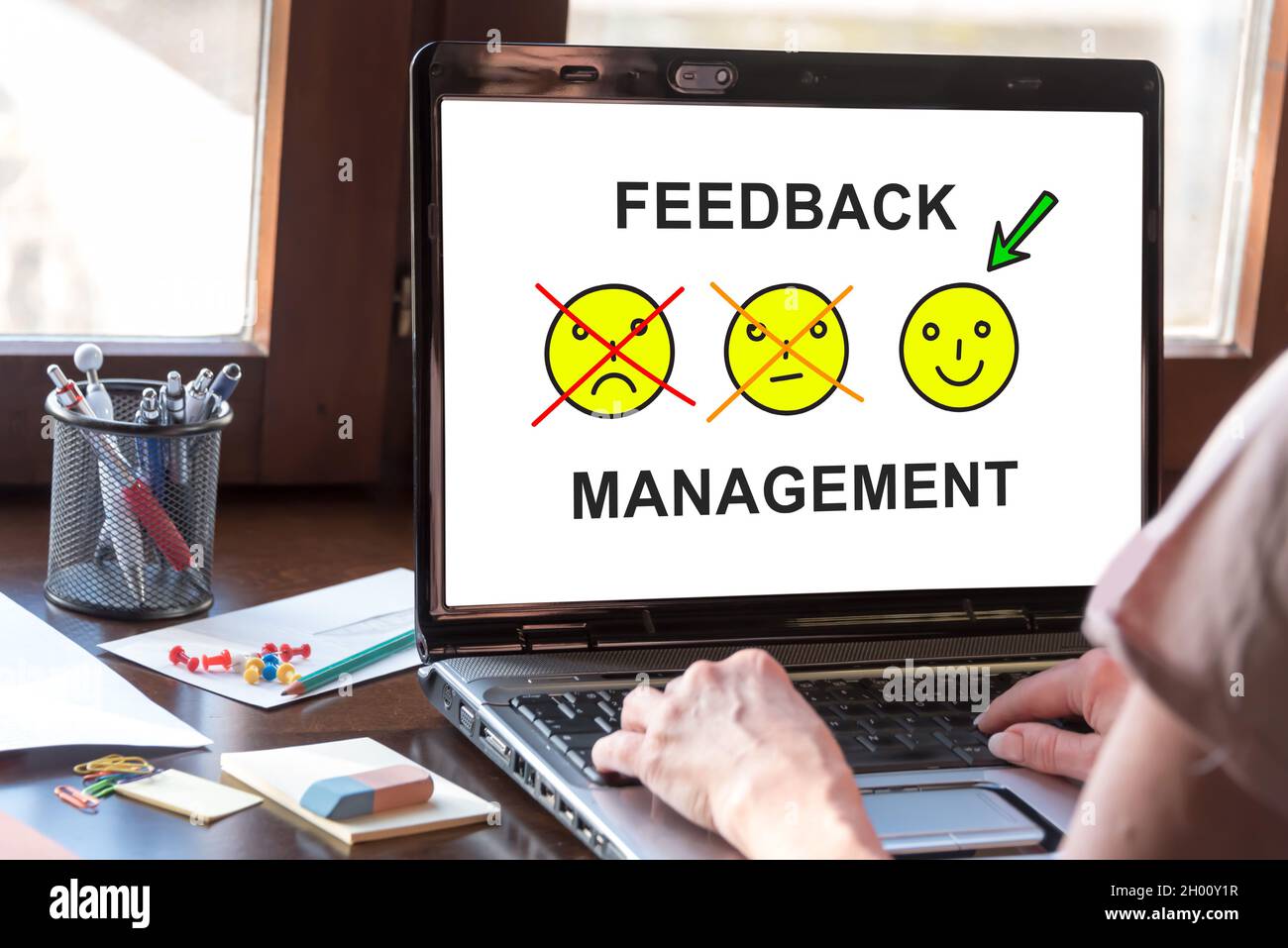 Laptop screen displaying a feedback management concept Stock Photo - Alamy