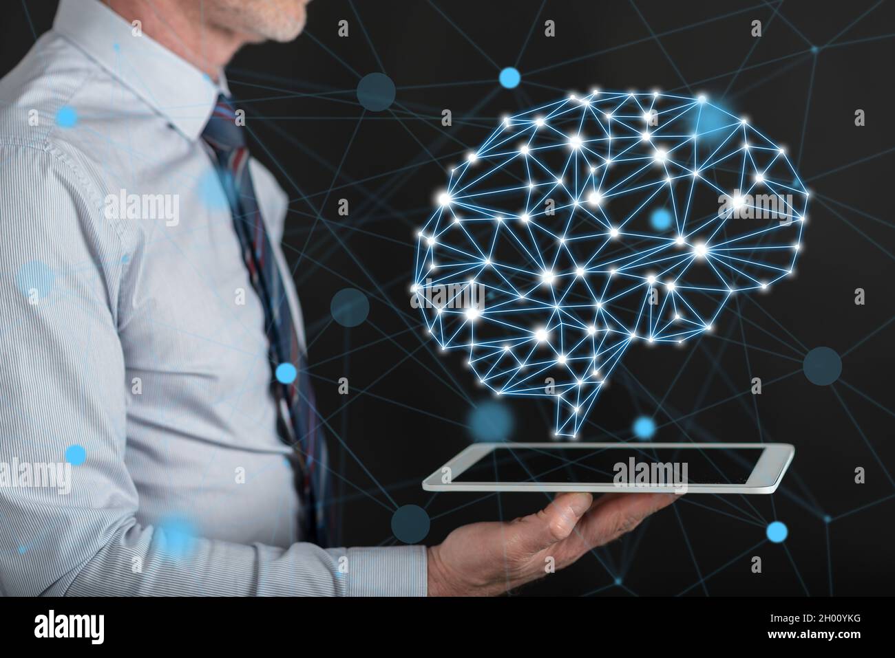Artificial intelligence concept above a tablet held by a man Stock ...