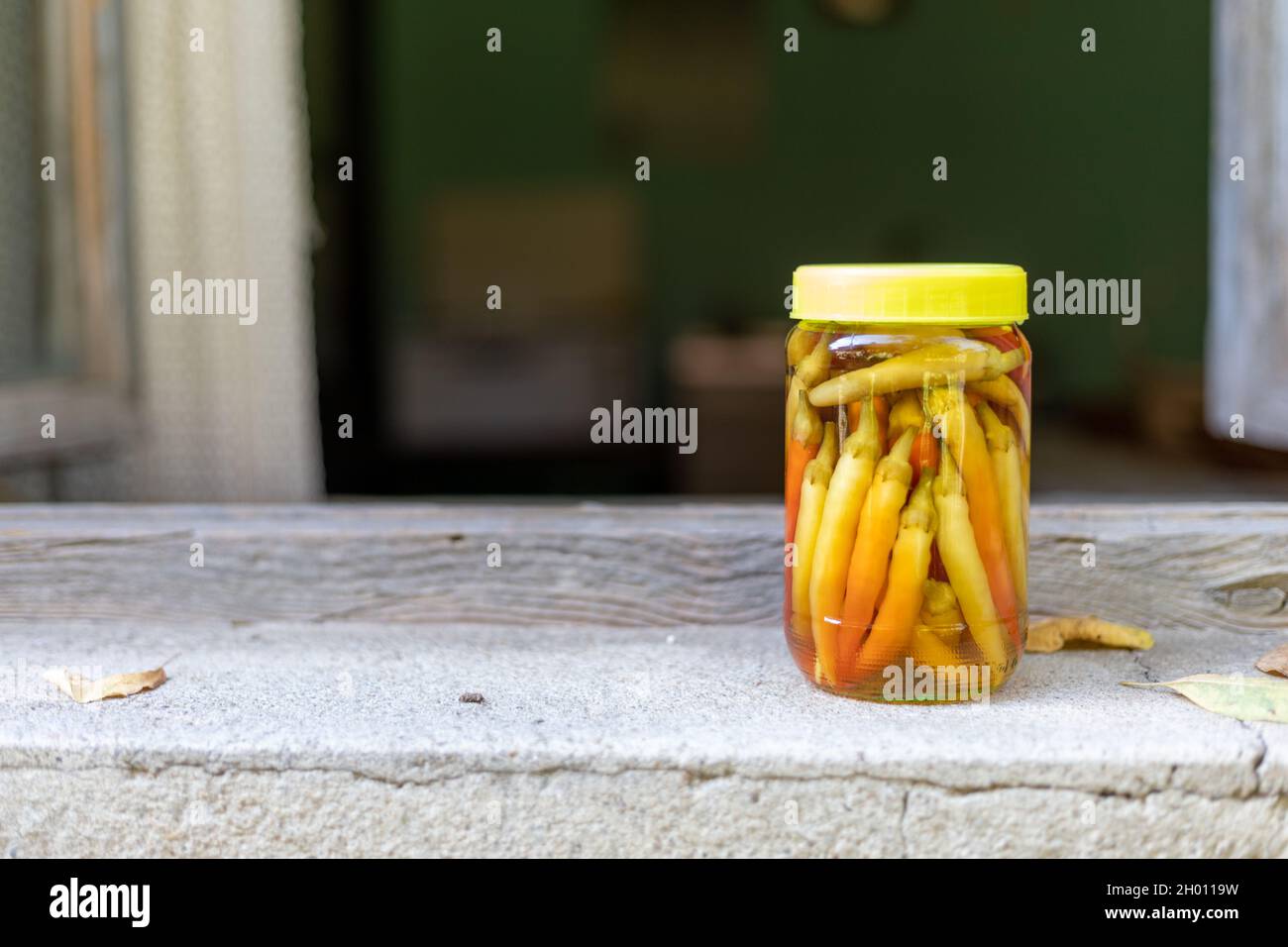 Fermented chili peppers in a glass jar. Winter preserved food Stock ...