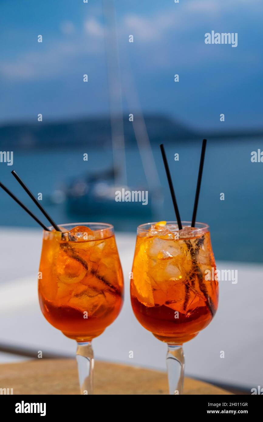 Orange drink or cocktail standing at the little table at the restaurant ...