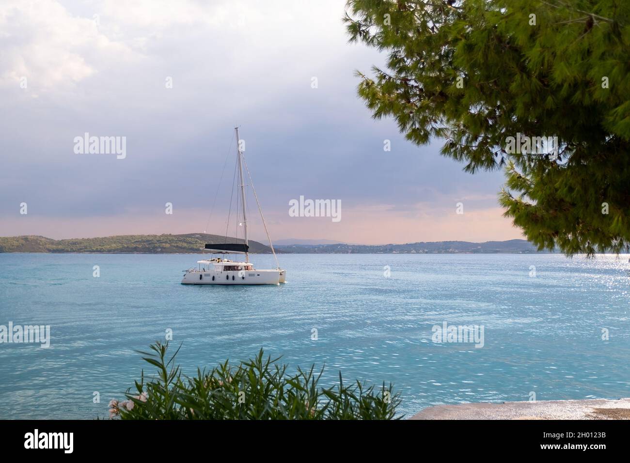 Catamaran sail Yacht cruising on deep blue sea water Stock Photo - Alamy