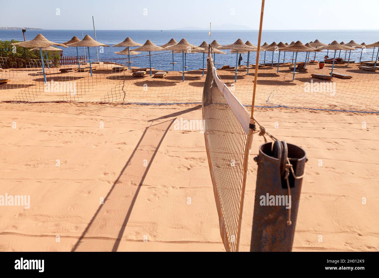 Volleyball net on tropical beach with blue sky. Closeup of net netting ...