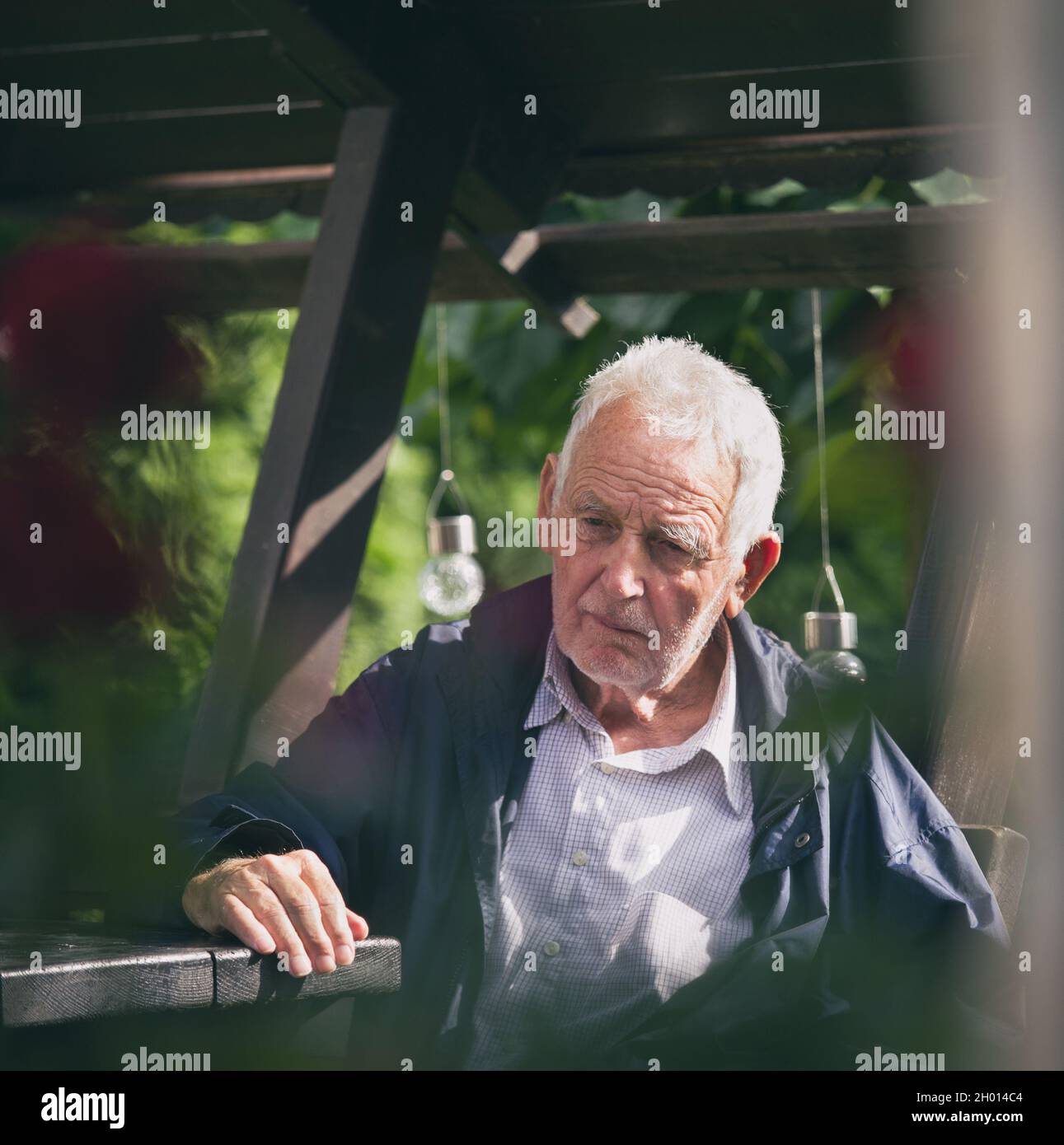 Portrait of old sad man with depressed facial expression, sitting on ...