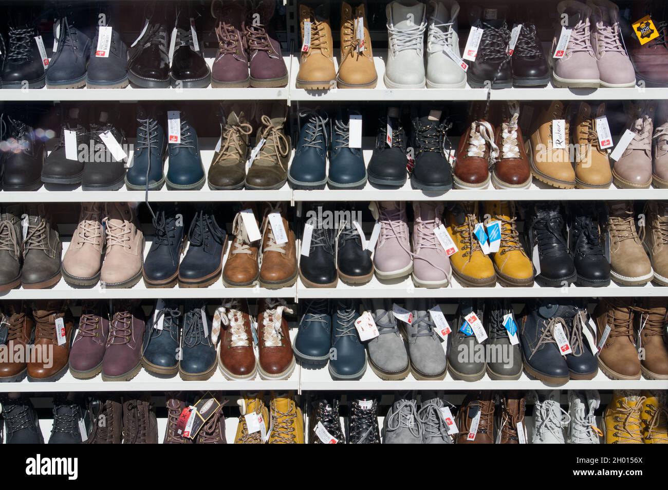 View through a shop window of a shoe store on a shelf with boots Stock ...