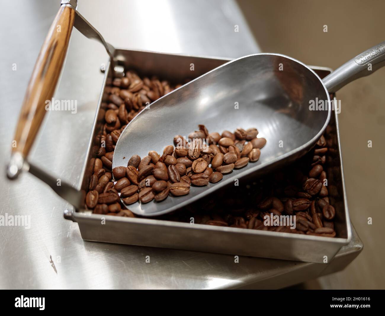 Container and scoop with roasted coffee beans Stock Photo - Alamy