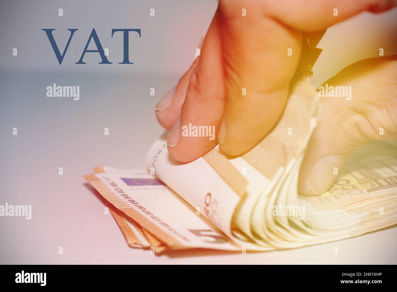 Hand counting money with the text “Vat” Stock Photo - Alamy