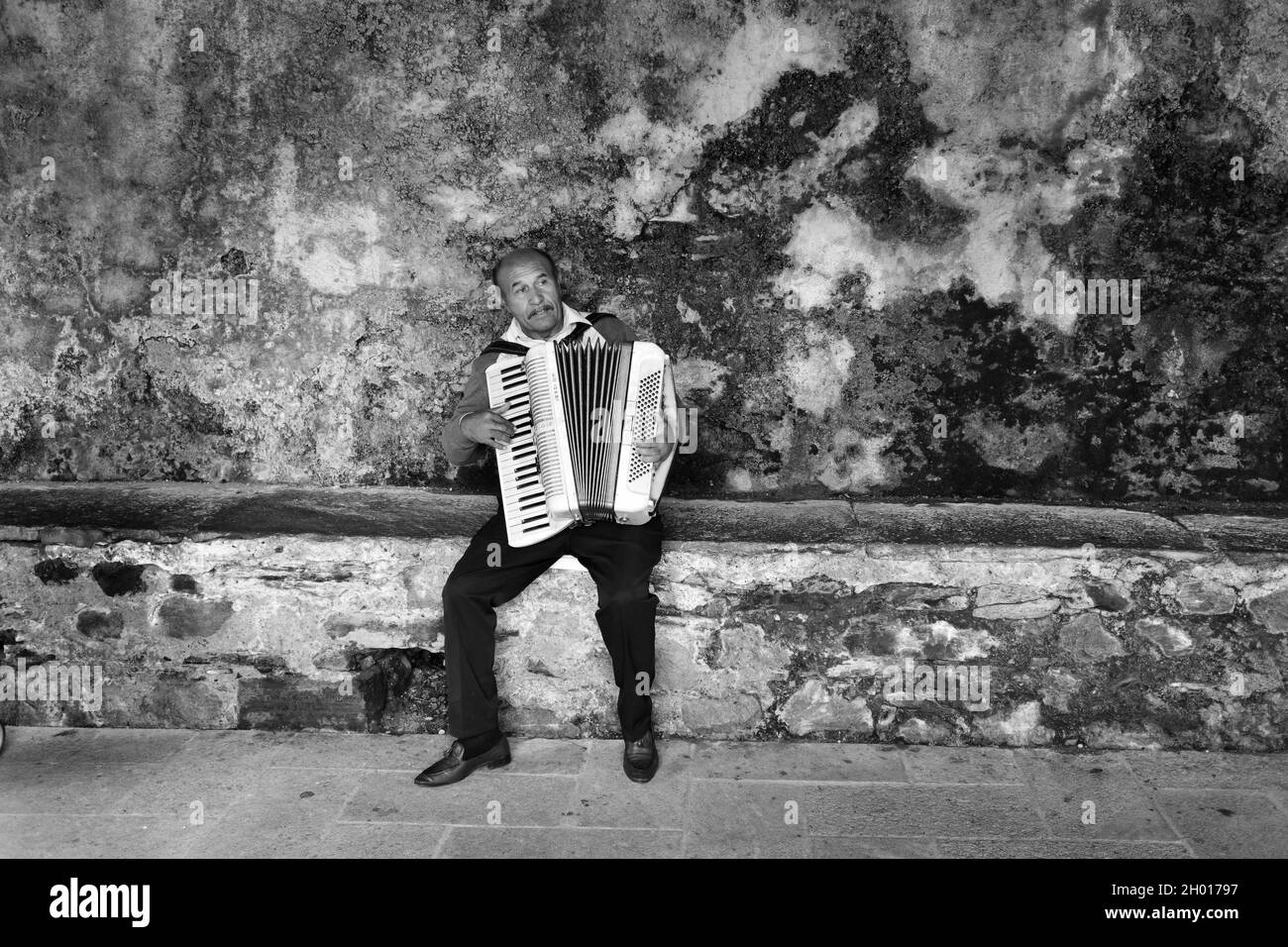 Man busking with piano accordion in Varenna on Lake Como, Italy Stock ...