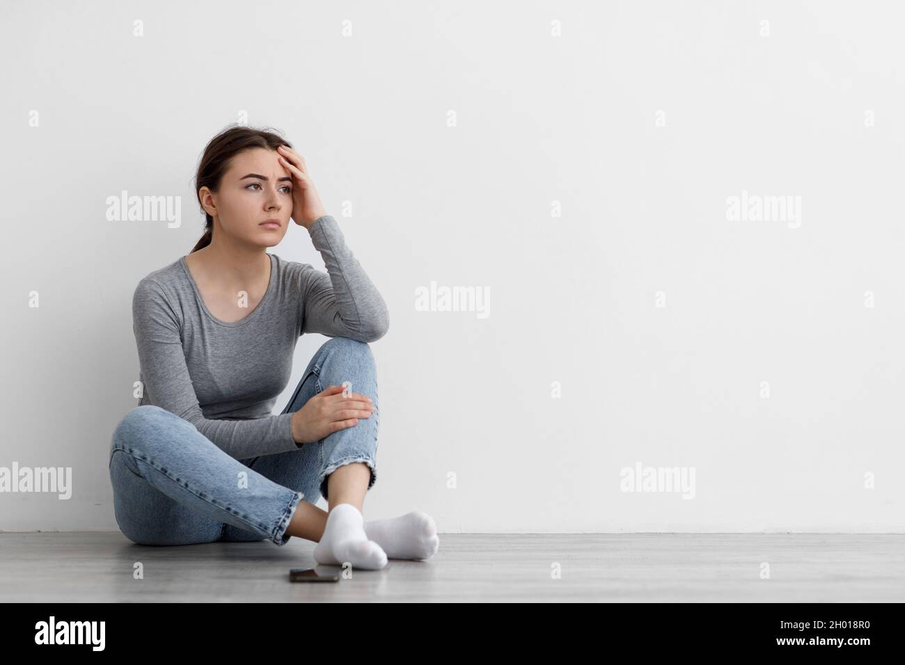 Frustrated sad worried caucasian young woman waiting for call and ...